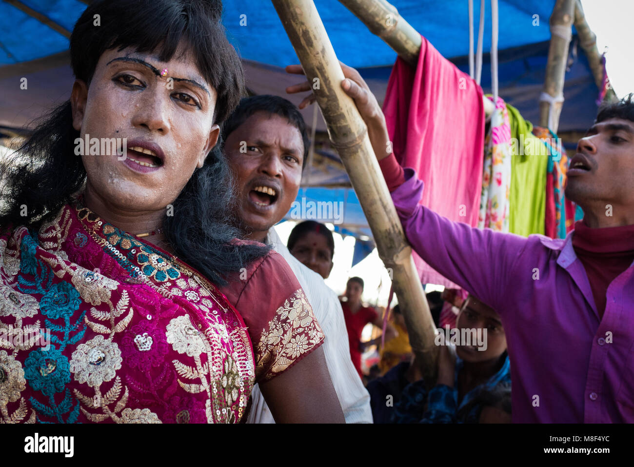 A hijra (cross-gender person) and other pilgrims at the Kartika Purnima ...