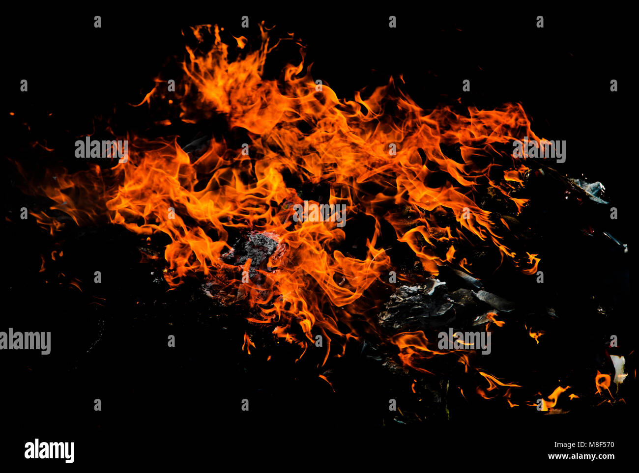 fire flame on black background. fire from burning paper and plastic ...