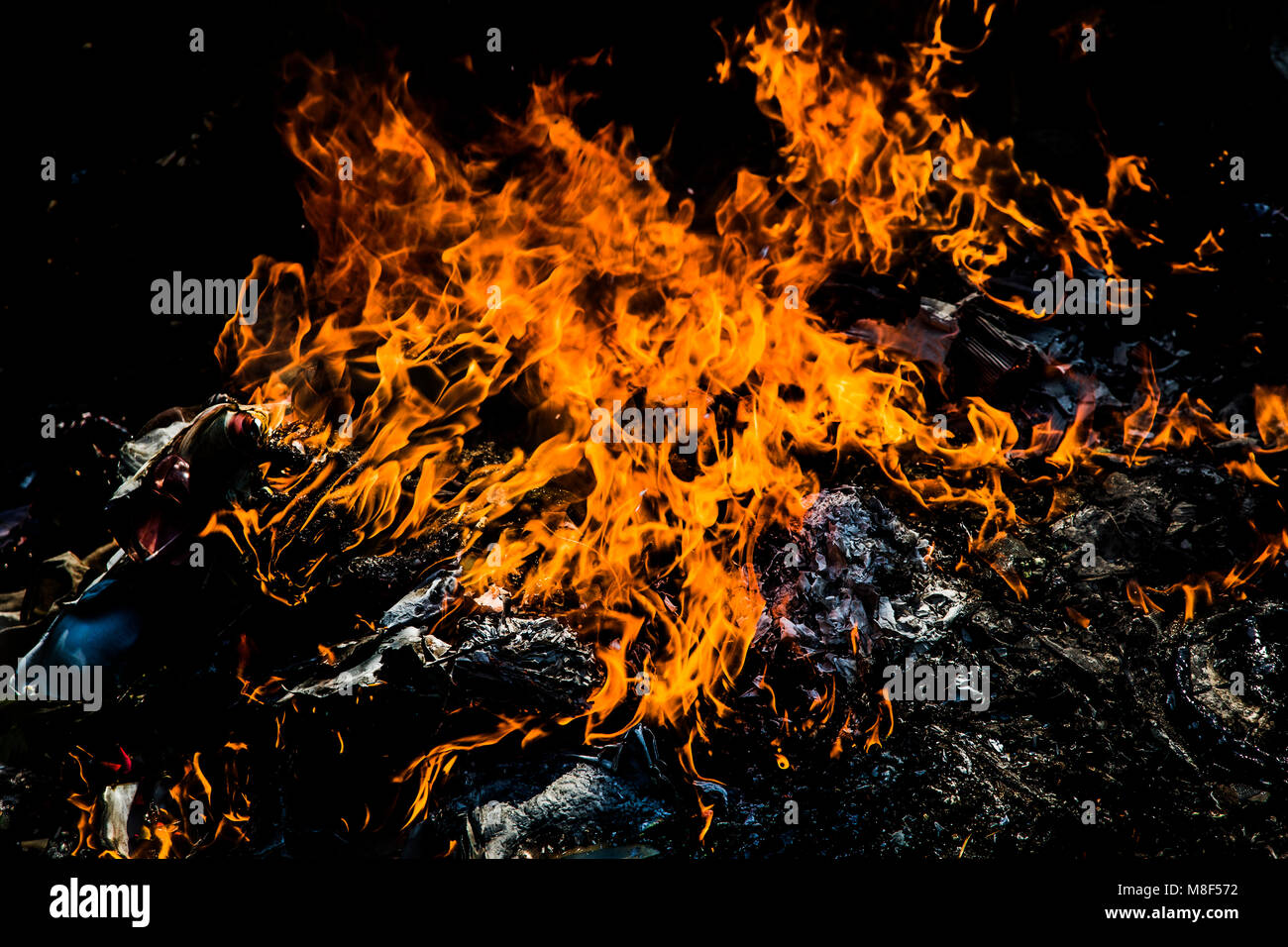 fire flame on black background. fire from burning paper and plastic ...
