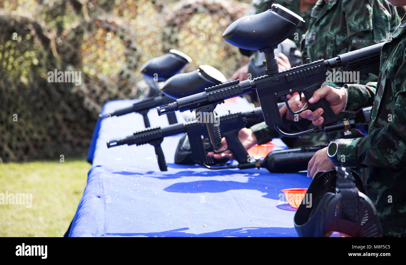 close up paint ball gun in shooting game outdoor activities with green ...