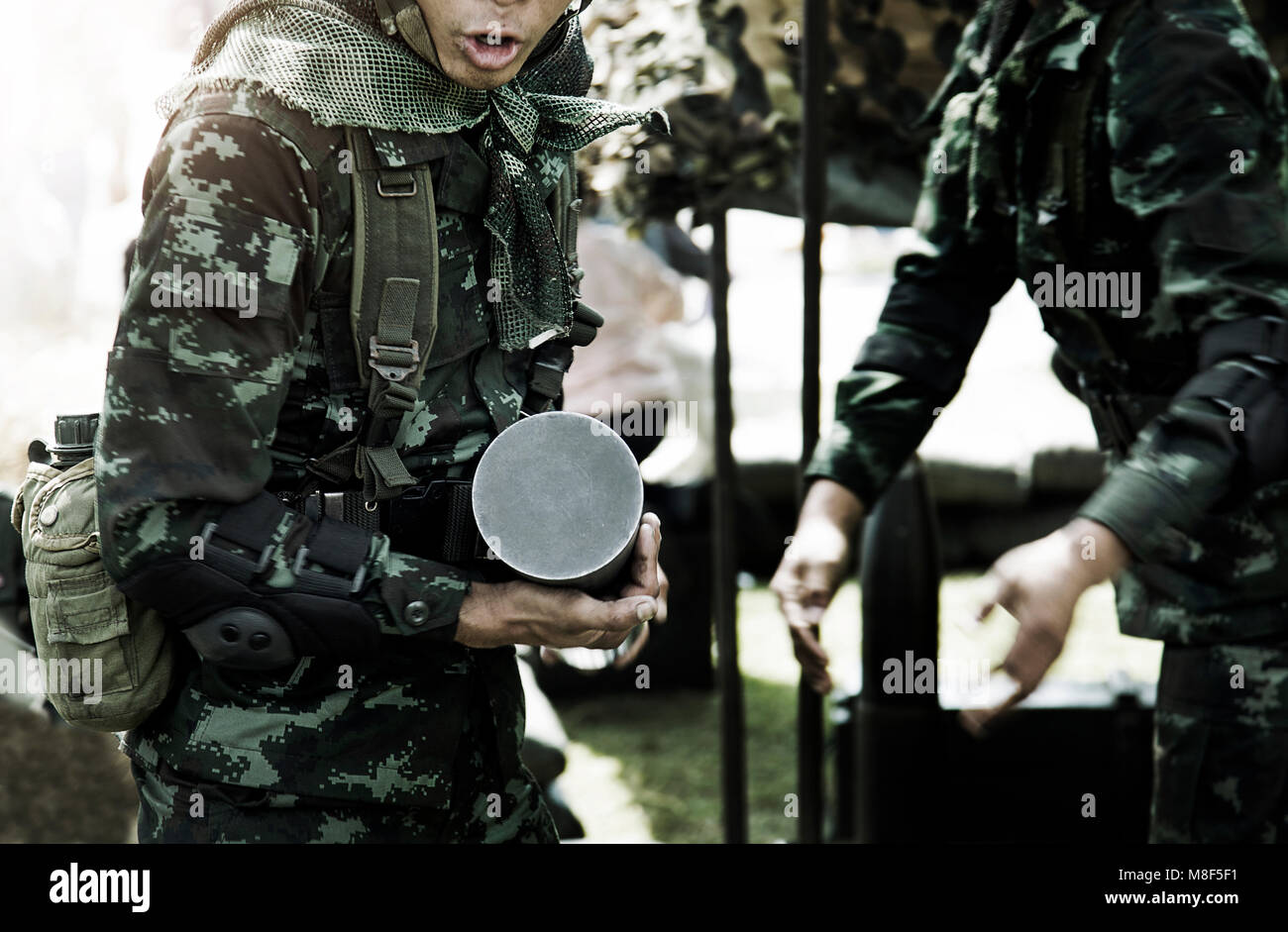 close up soldier holding canon bullet in war with team work Stock Photo ...