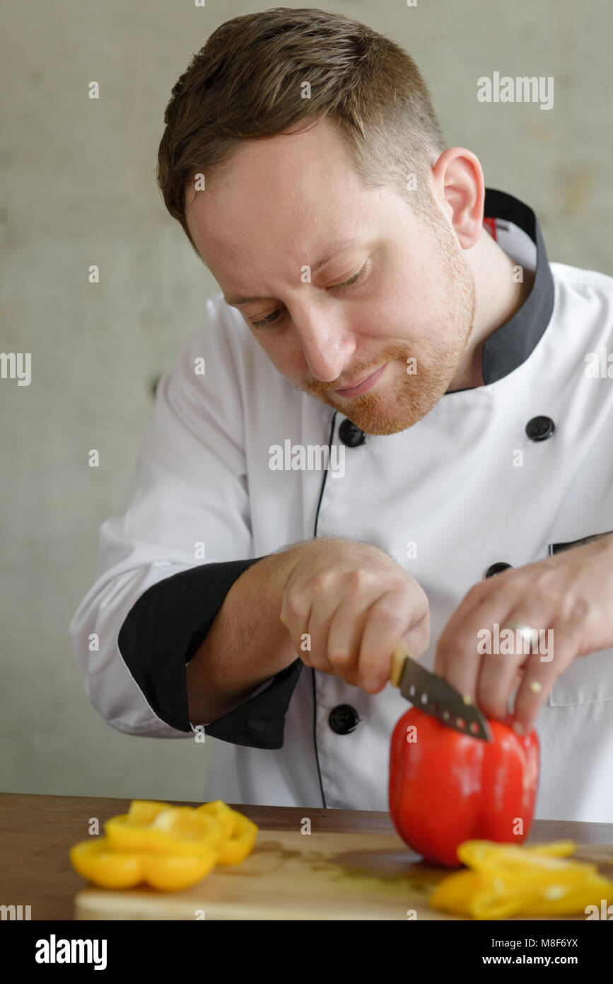 Professional chef chopping chili peppers for preparing food Stock Photo ...