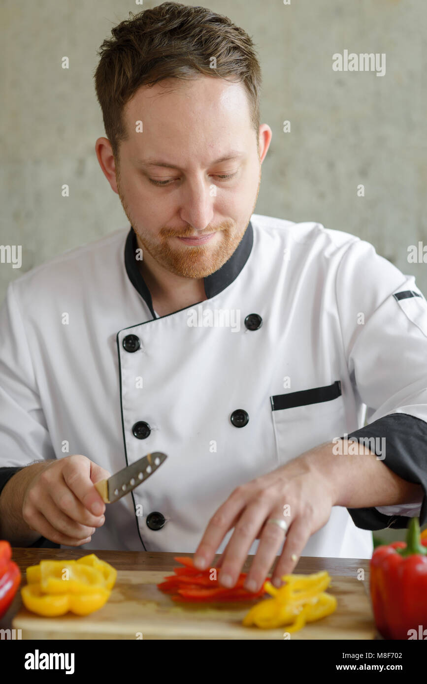 Professional chef chopping chili peppers for preparing food Stock Photo ...