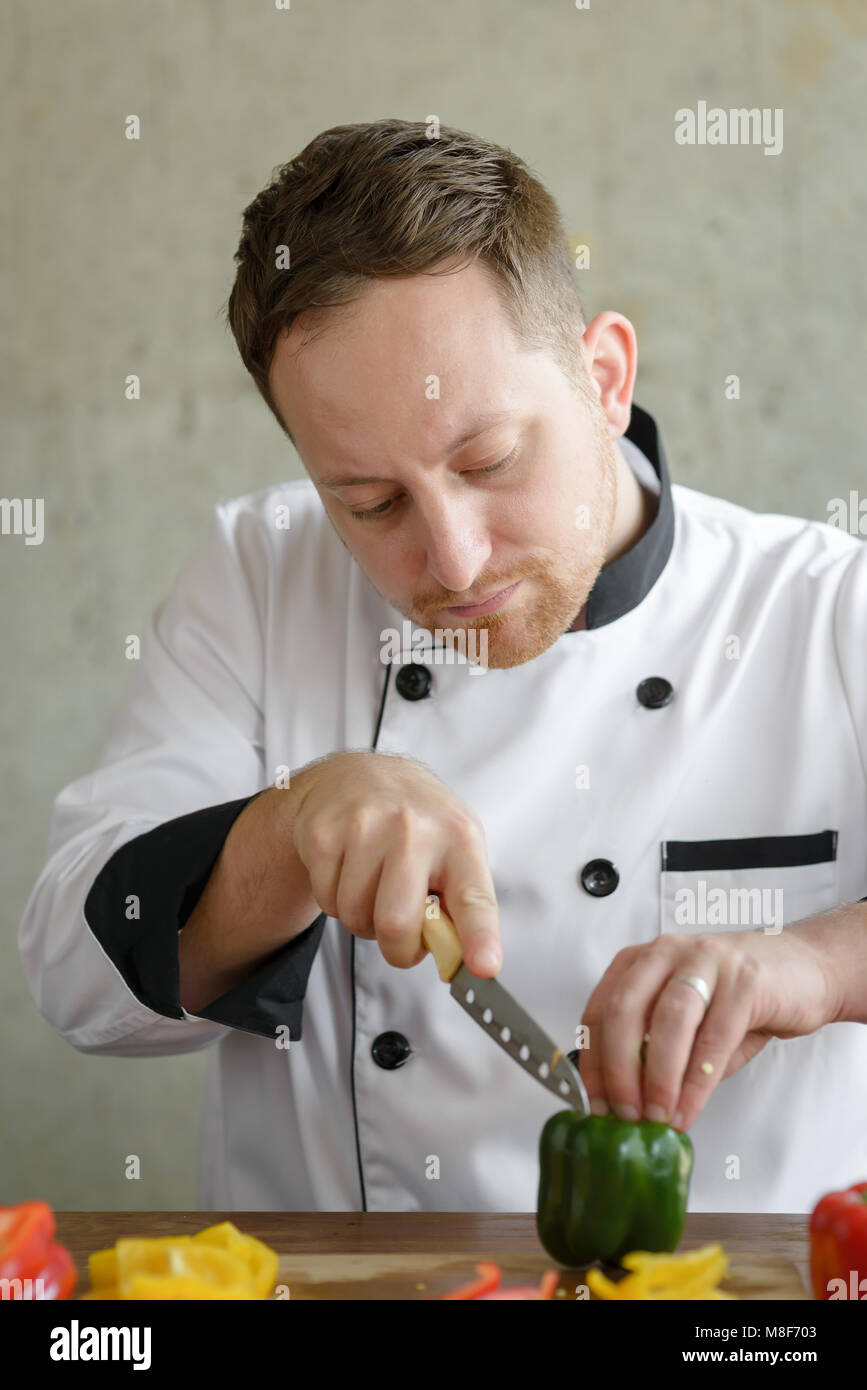 Professional chef chopping chili peppers for preparing food Stock Photo ...