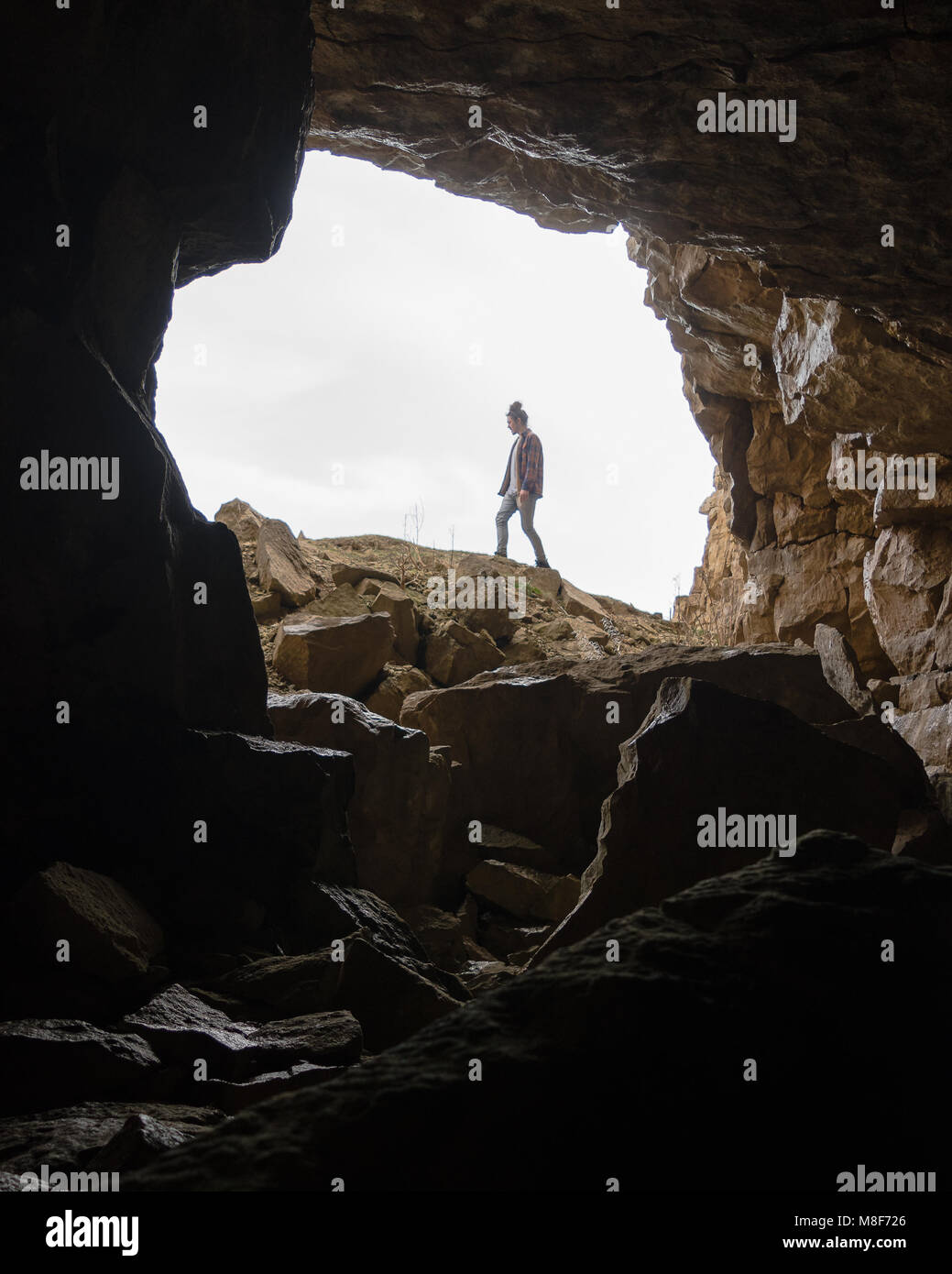 Man exploring caves along the Jurassic Coastline, Dorset, UK Stock ...