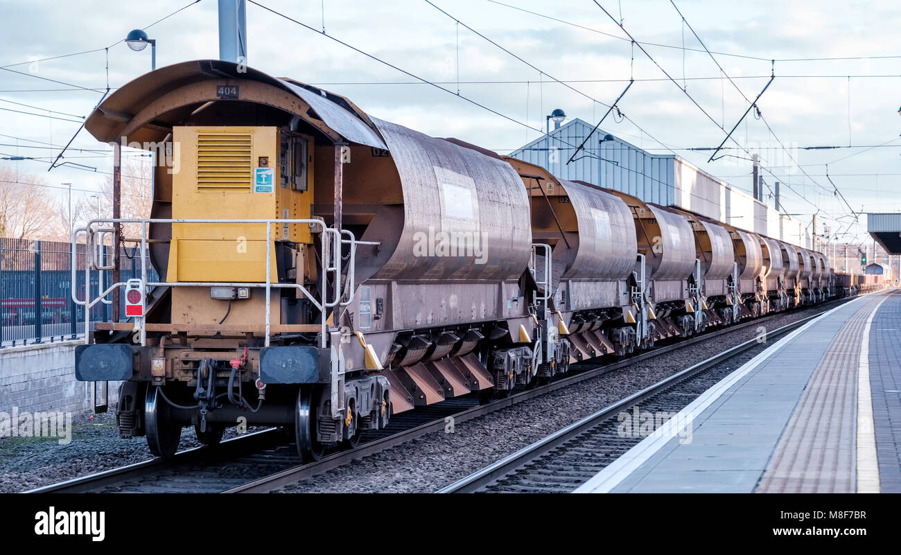 A diesel locomotive pulling old sections of rail track Stock Photo - Alamy