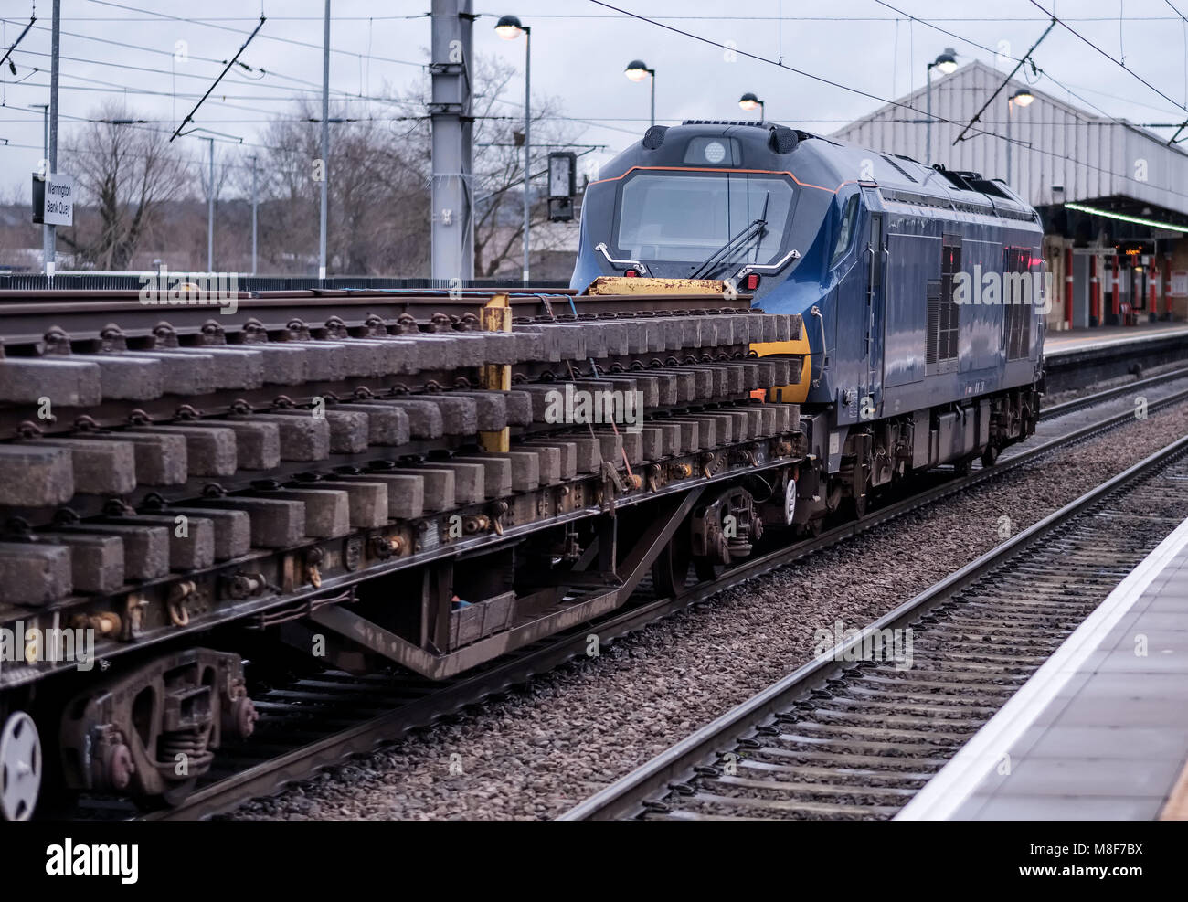 A diesel locomotive pulling old sections of rail track Stock Photo - Alamy