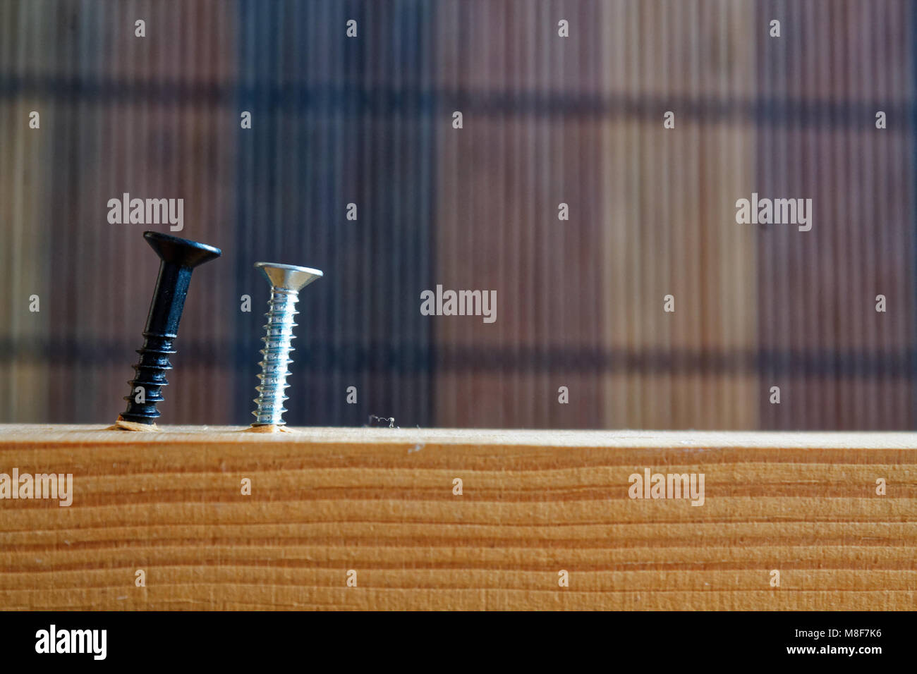 Scattered screws screwed into the wooden plank Stock Photo - Alamy