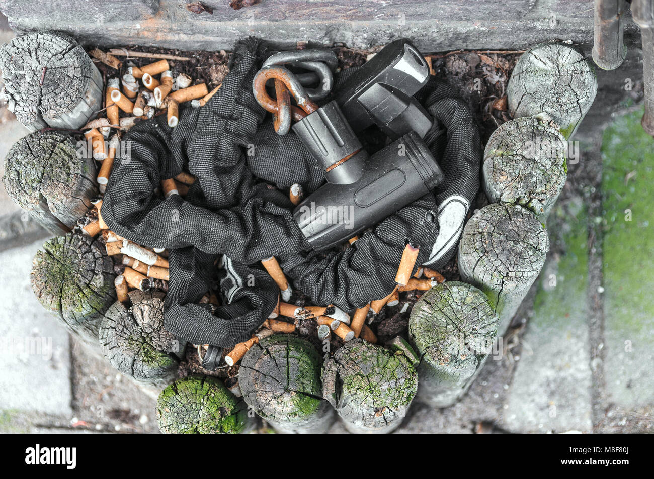 bicycle lock lying in an ashtray in an outdoor area Stock Photo - Alamy