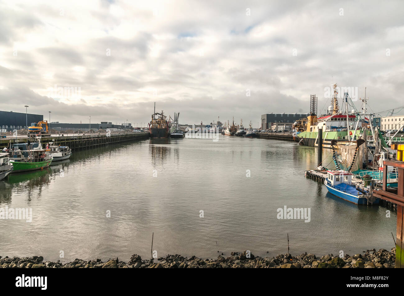 a beautiful view of a Dutch fishing port with fishing boats moored ...
