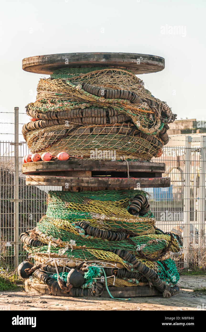 large wooden pulley with fishing nets wrapped around it Stock Photo - Alamy