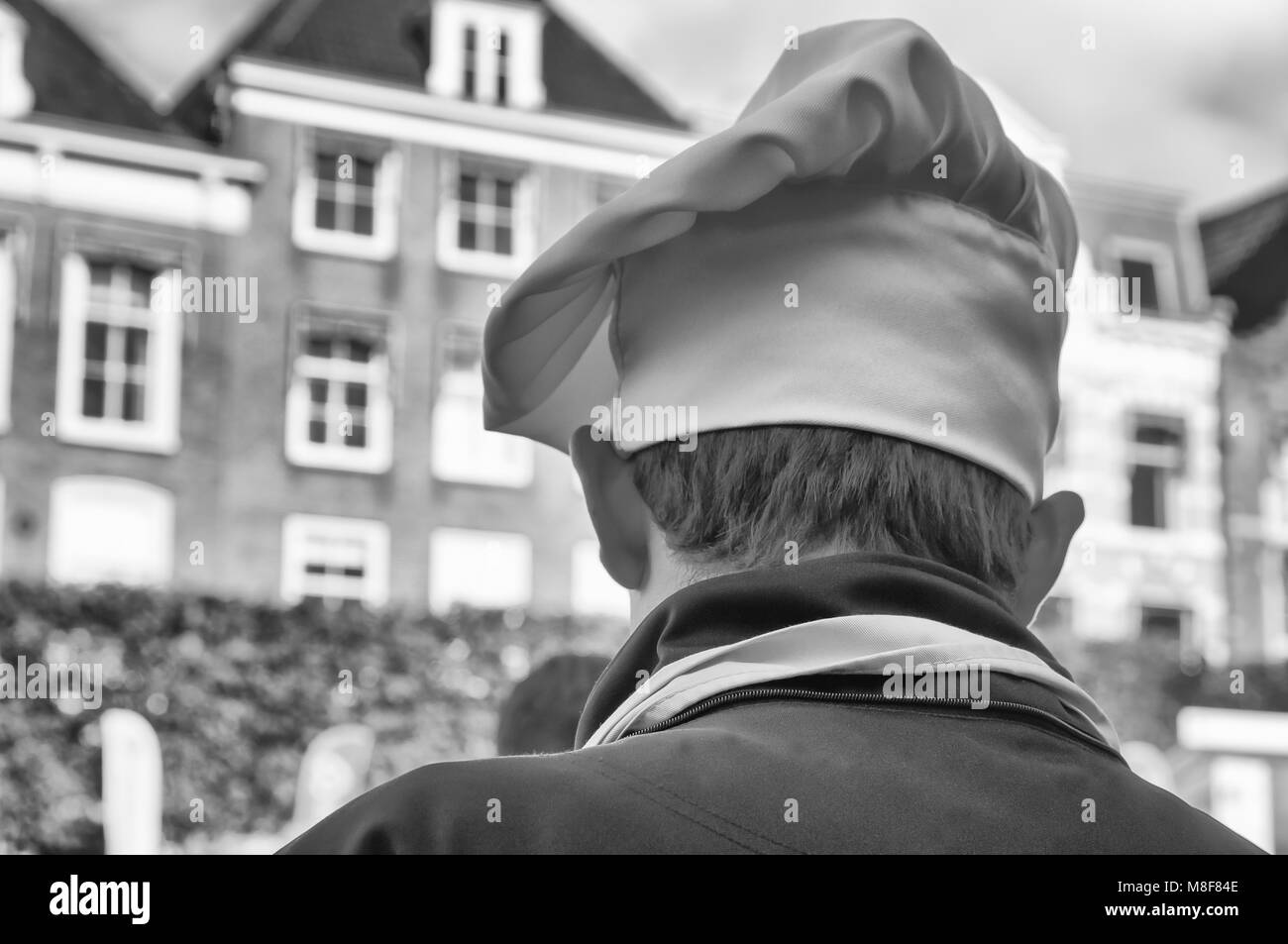 black and white photo of a man with a baker's hat on his head Stock ...