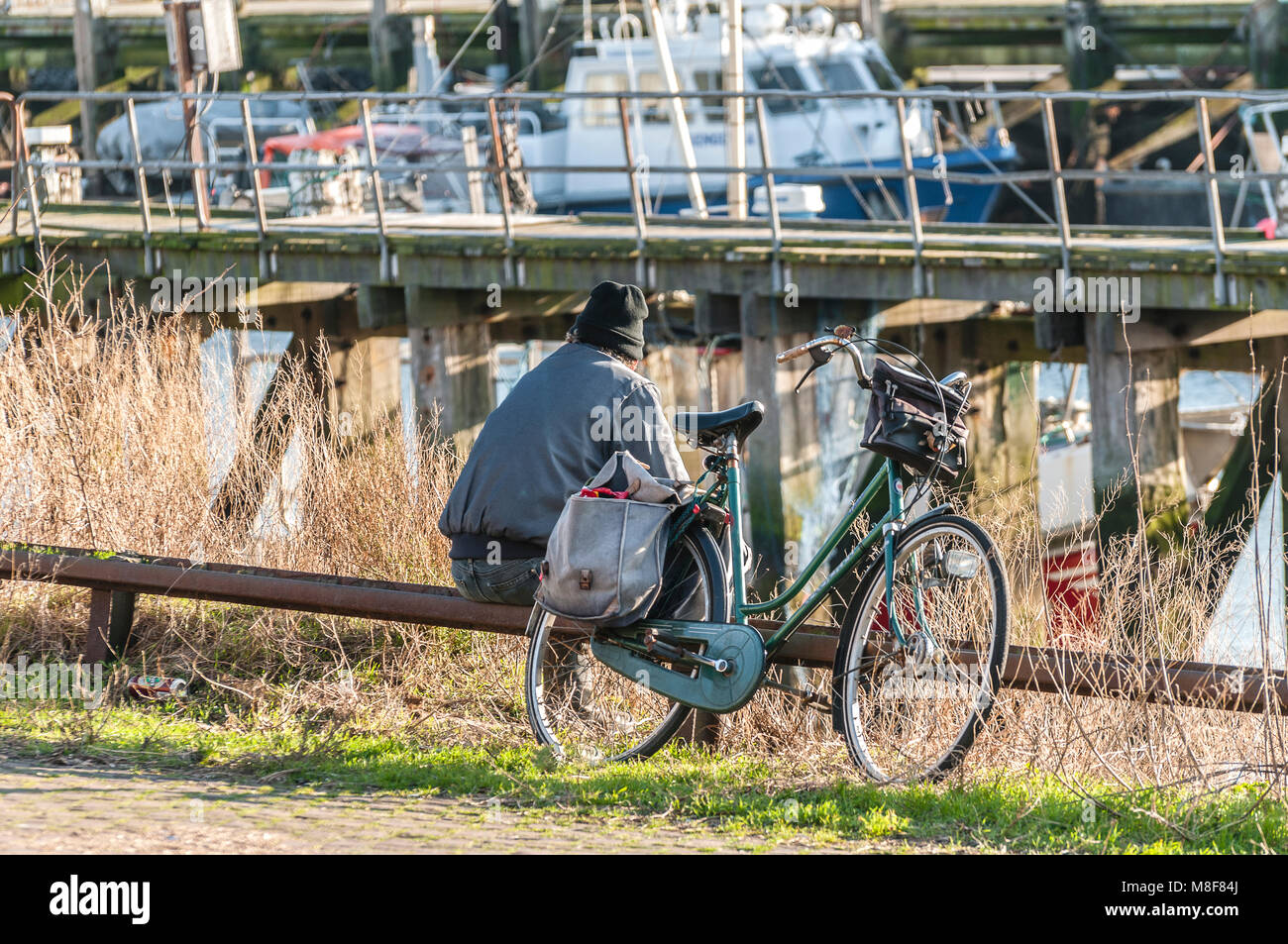 Man sitting on railing hi-res stock photography and images - Alamy