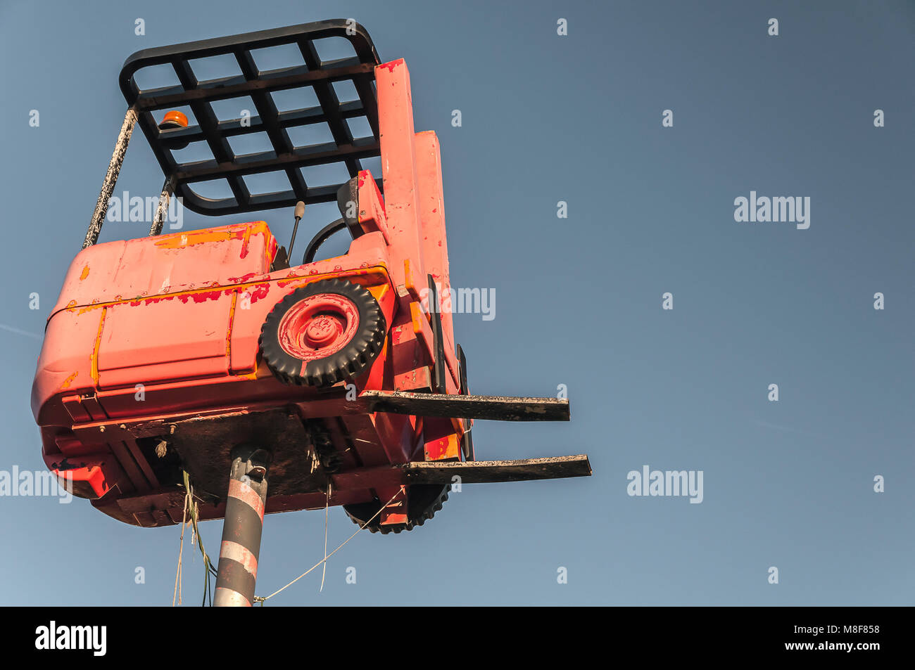 red forklift in the air placed on a steel pipe Stock Photo - Alamy