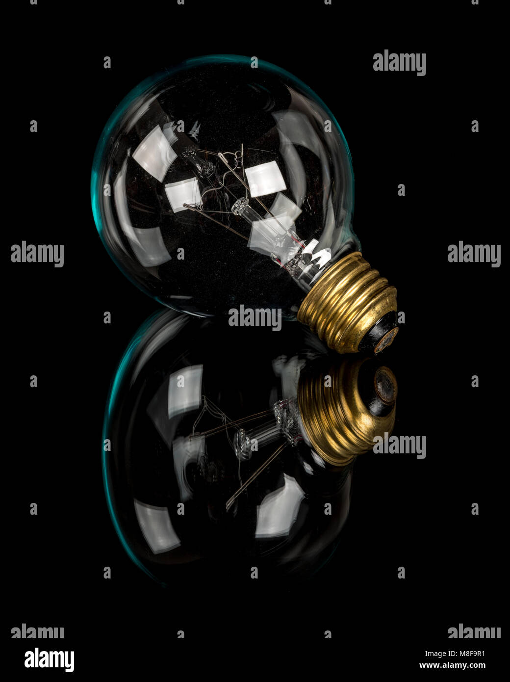 Glass see through light bulb with reflection Stock Photo - Alamy