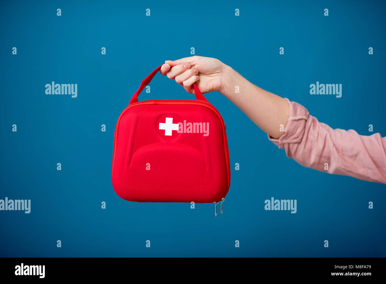 First aid kit on the blue background Stock Photo - Alamy