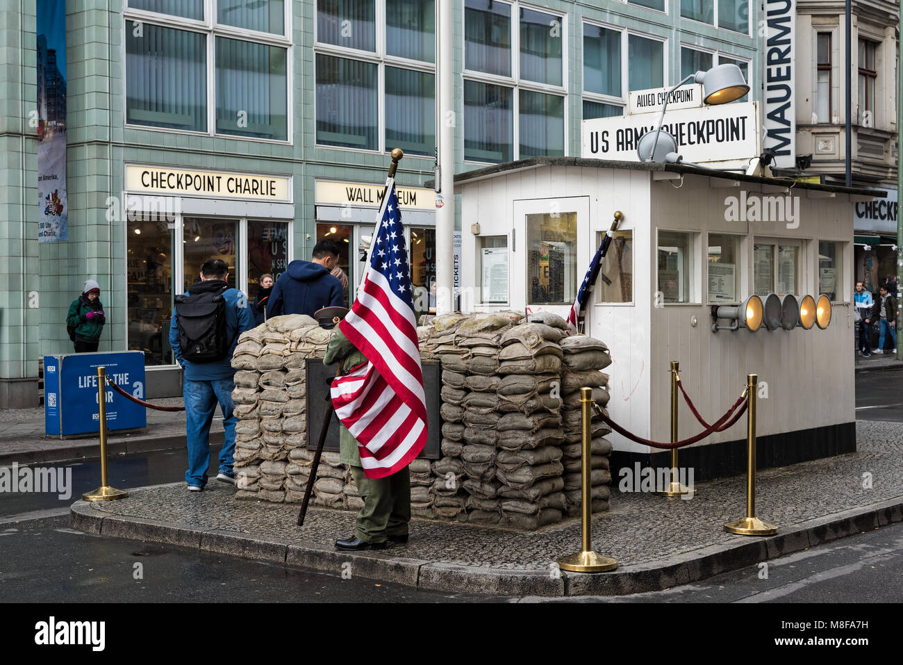 Men wearing american military uniforms stand at the famous Checkpoint ...