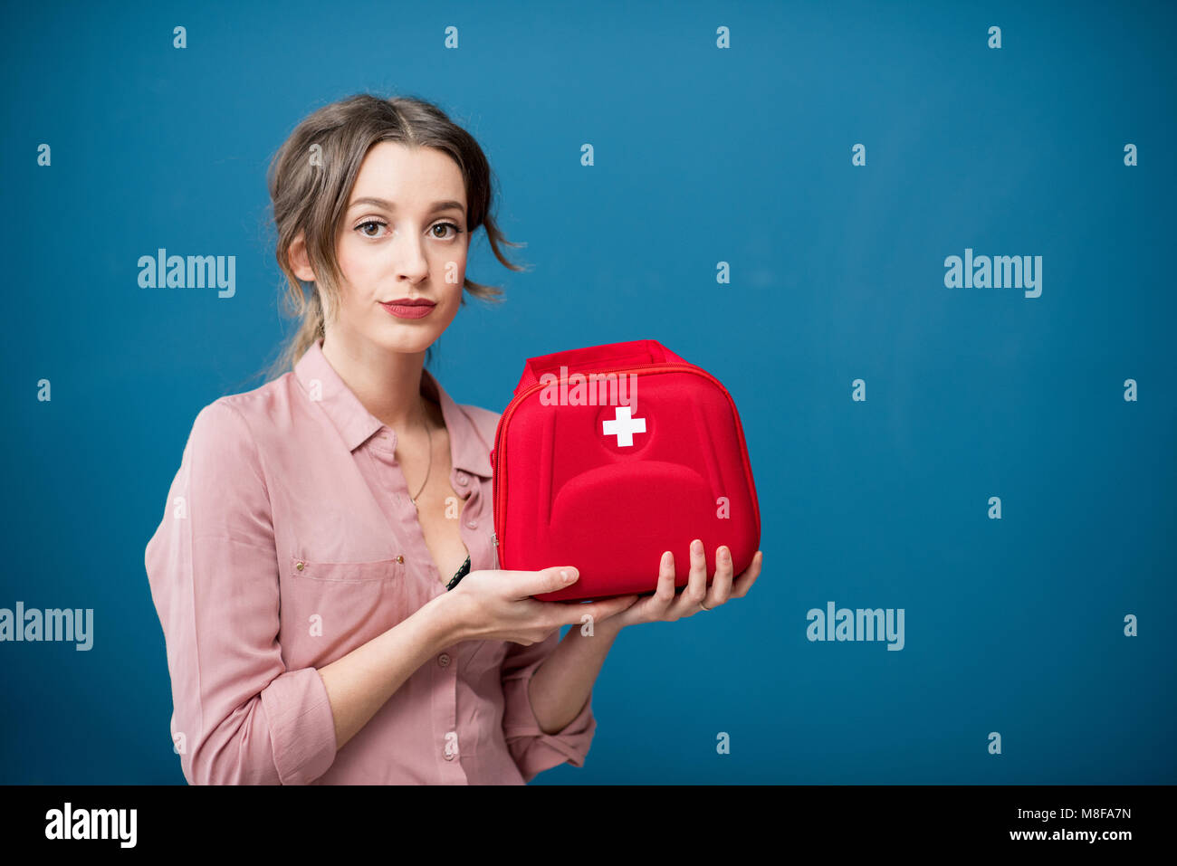 Woman with first aid kit Stock Photo - Alamy
