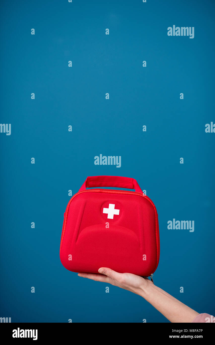 First aid kit on the blue background Stock Photo - Alamy
