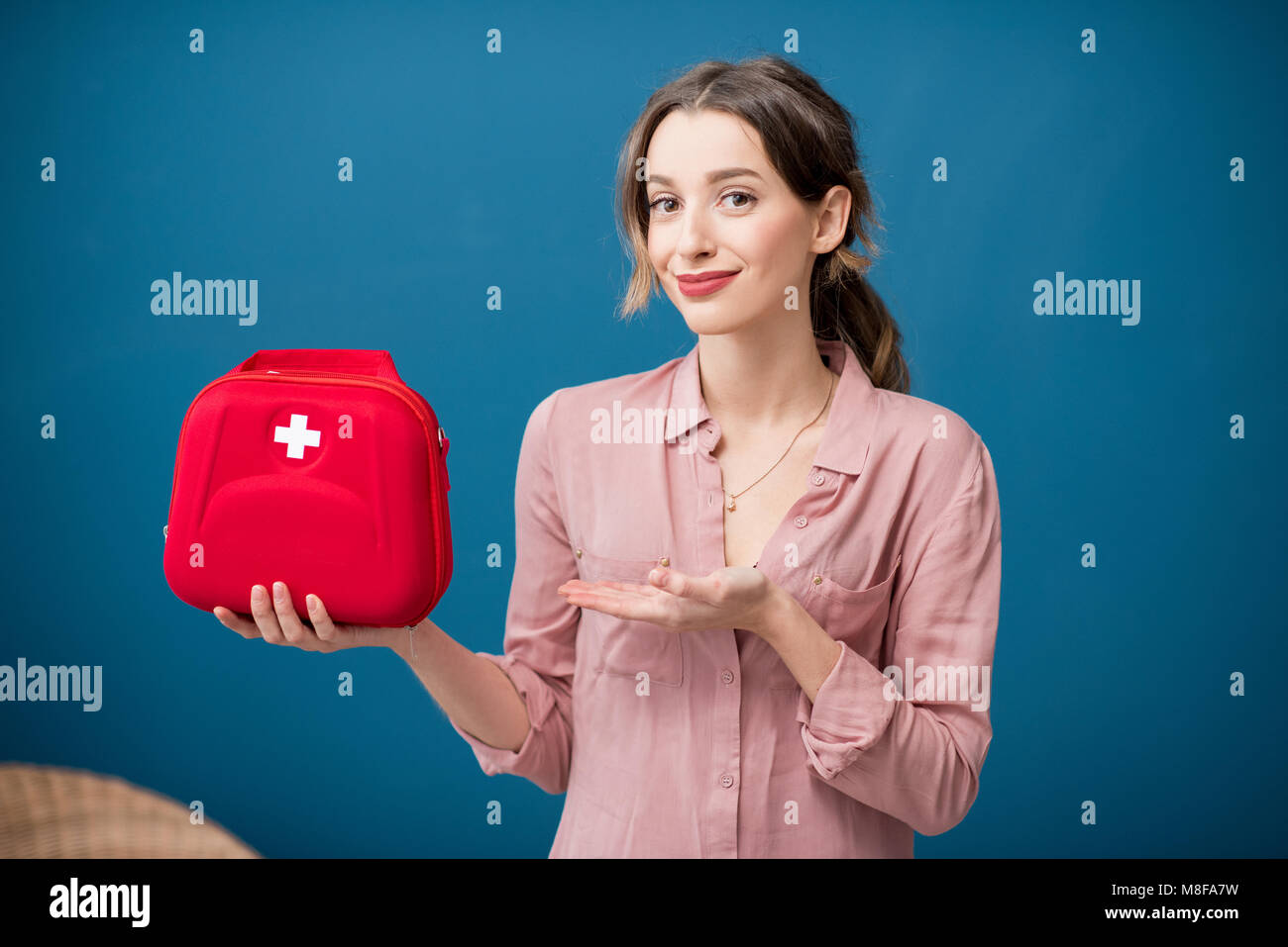 Woman with first aid kit Stock Photo - Alamy