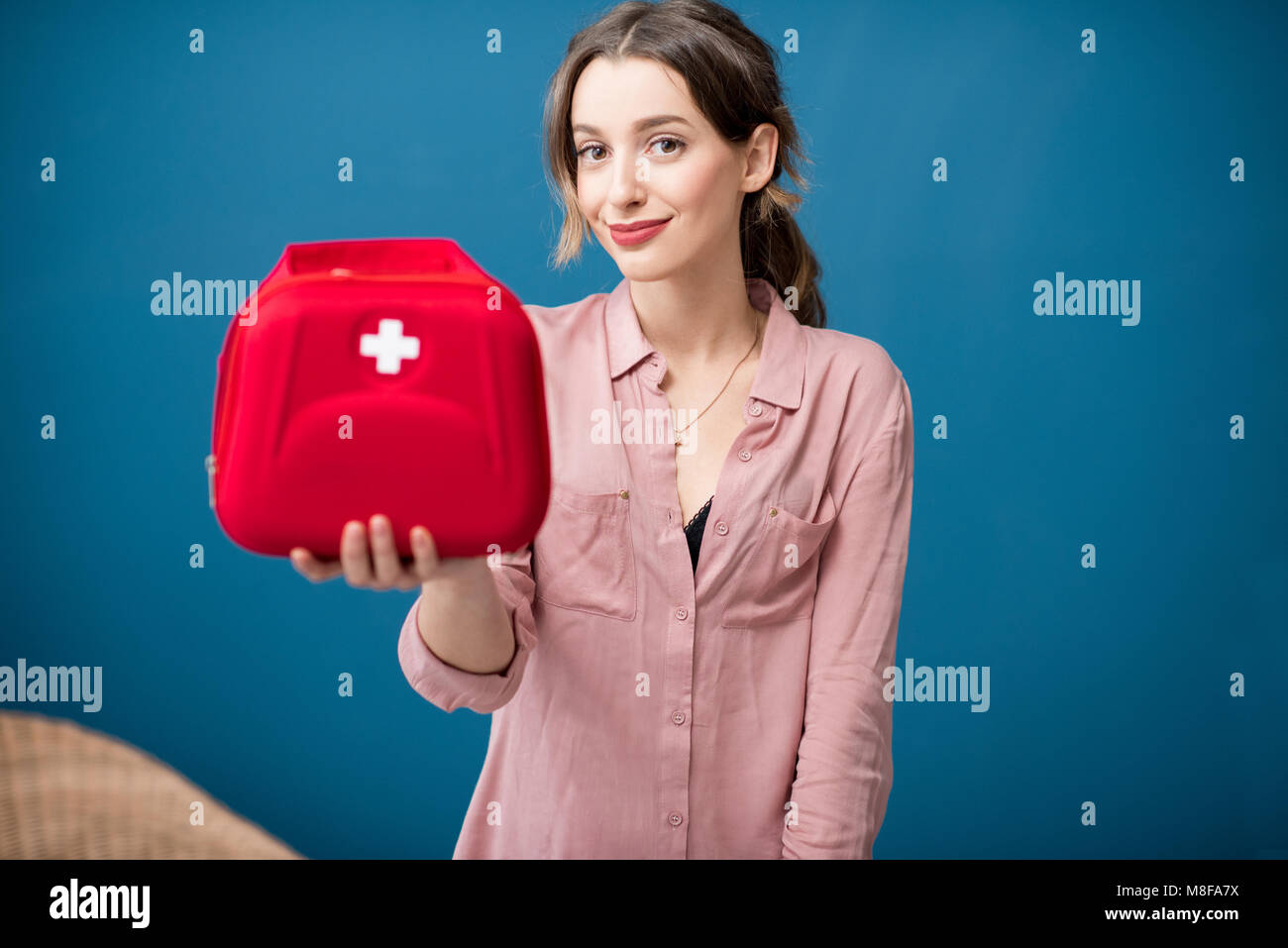 Woman with first aid kit Stock Photo - Alamy