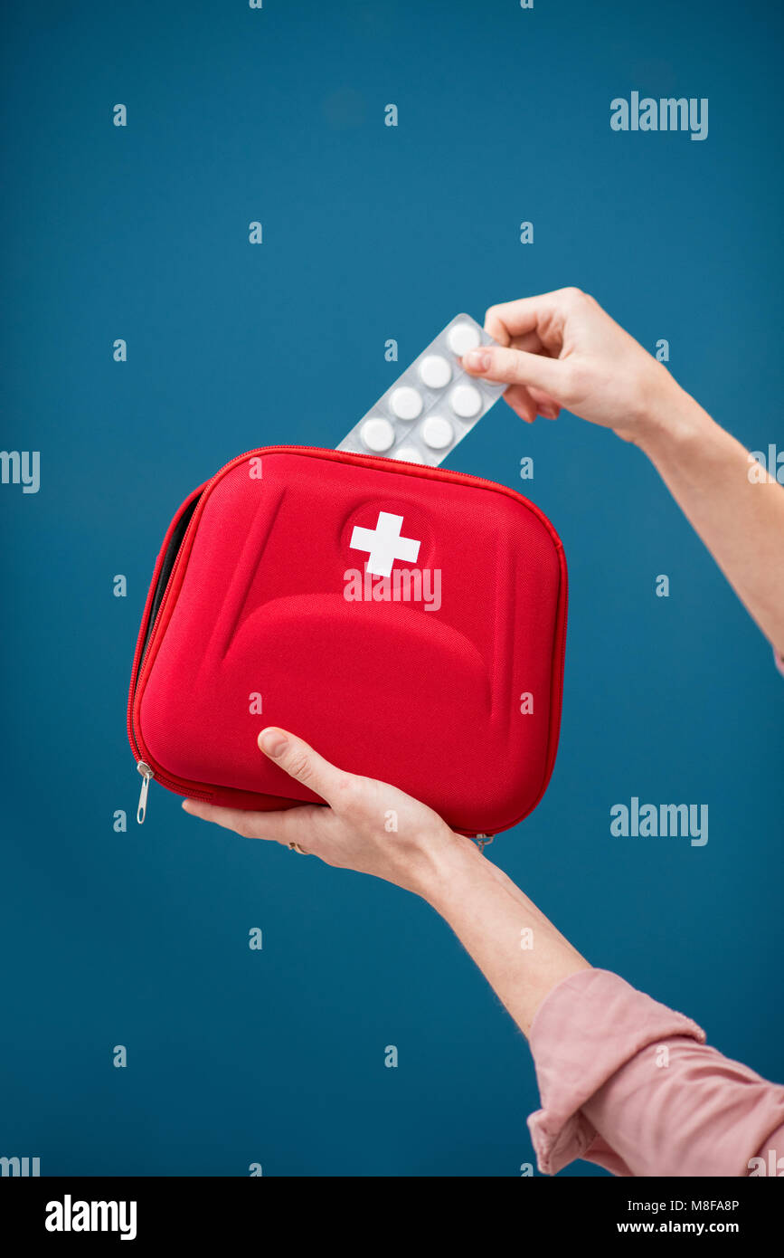 Getting a pills from first aid kit Stock Photo - Alamy