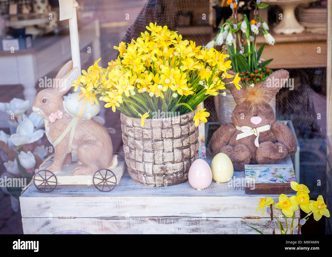 Easter theme in the showcase of a souvenir shop. Flowers, toys and ...