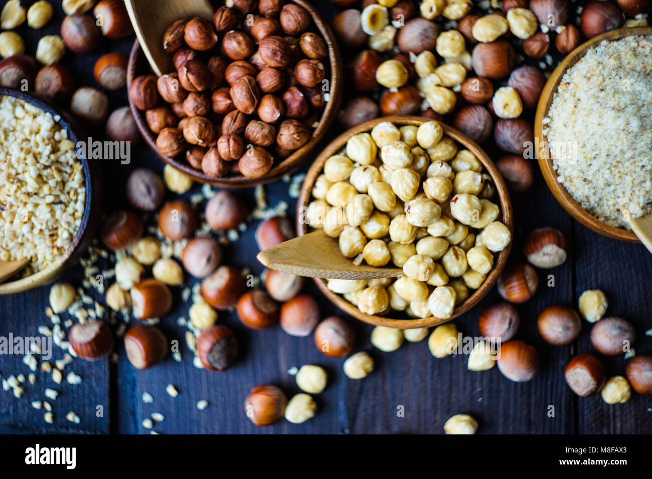 Different types of hazelnuts on dark wooden background with copyspace ...