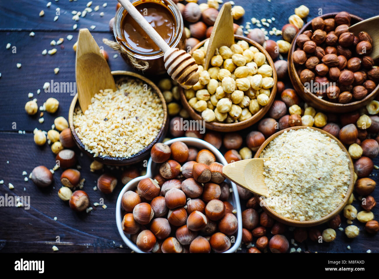 Different types of hazelnuts on dark wooden background with copyspace ...