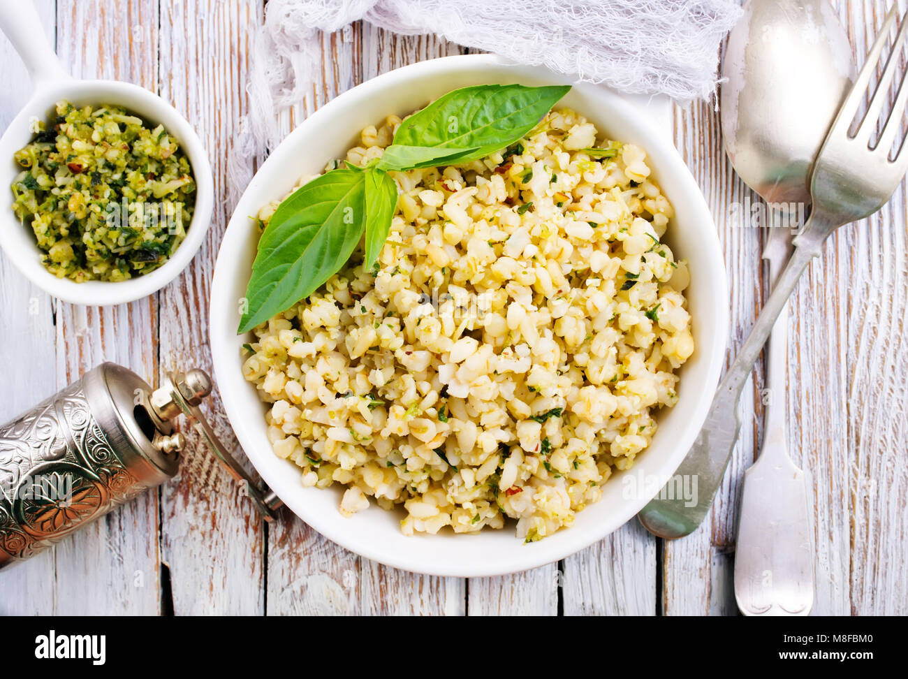 boiled bulgur with sauce Pesto in white bowl Stock Photo - Alamy