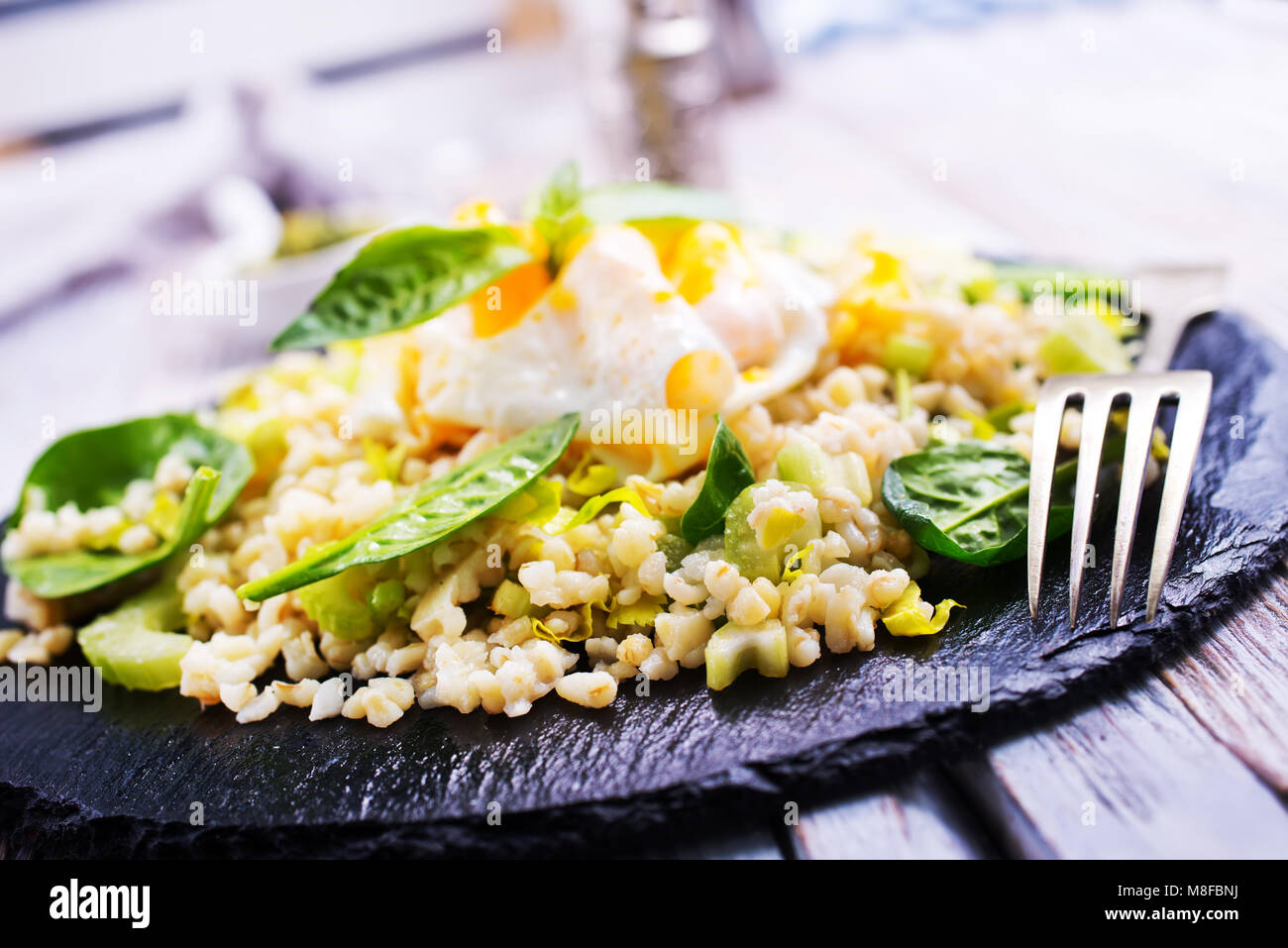 fried bulgur with basil and fried chicken egg Stock Photo - Alamy