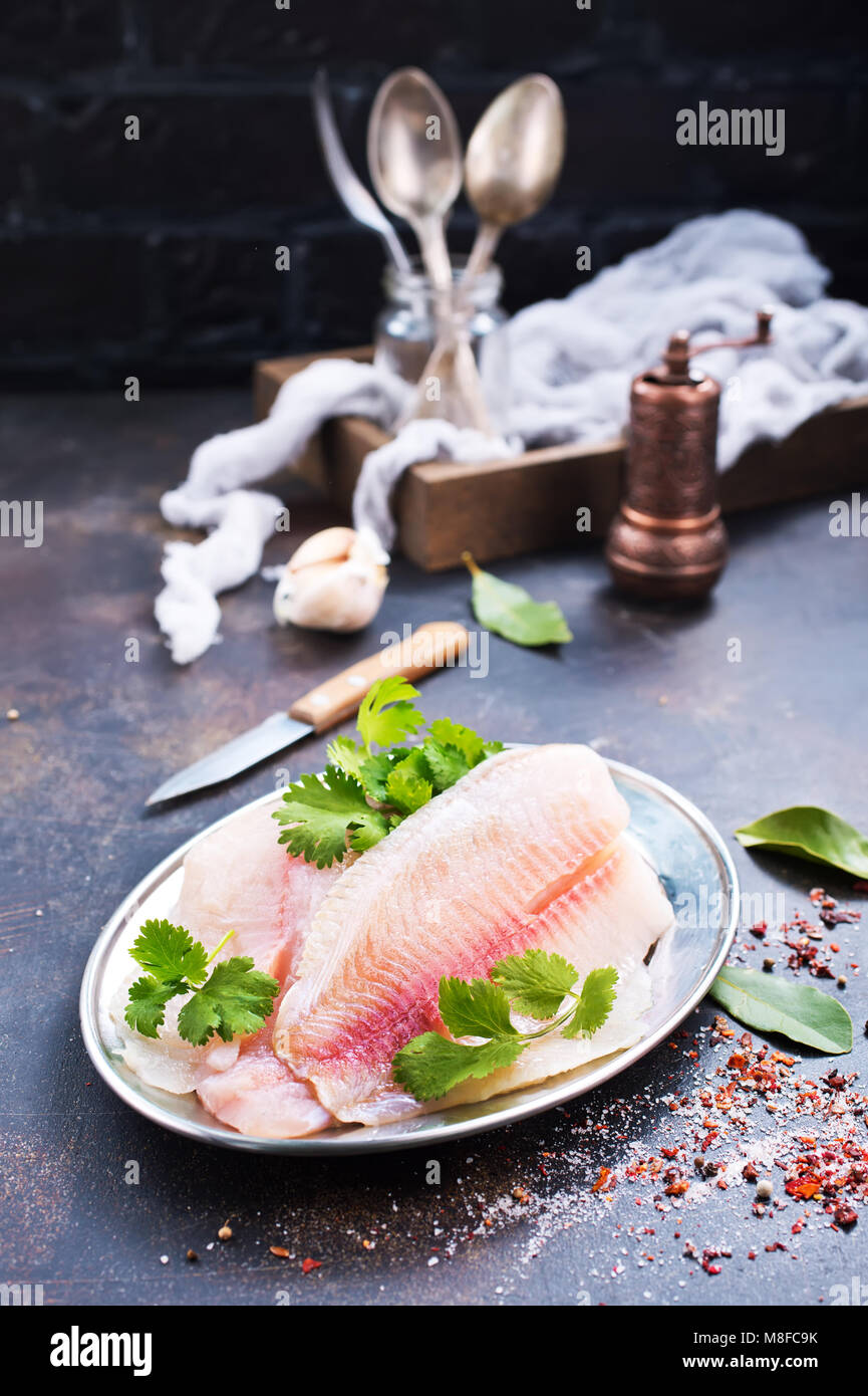 raw fish fillet with aroma spice on plate Stock Photo - Alamy