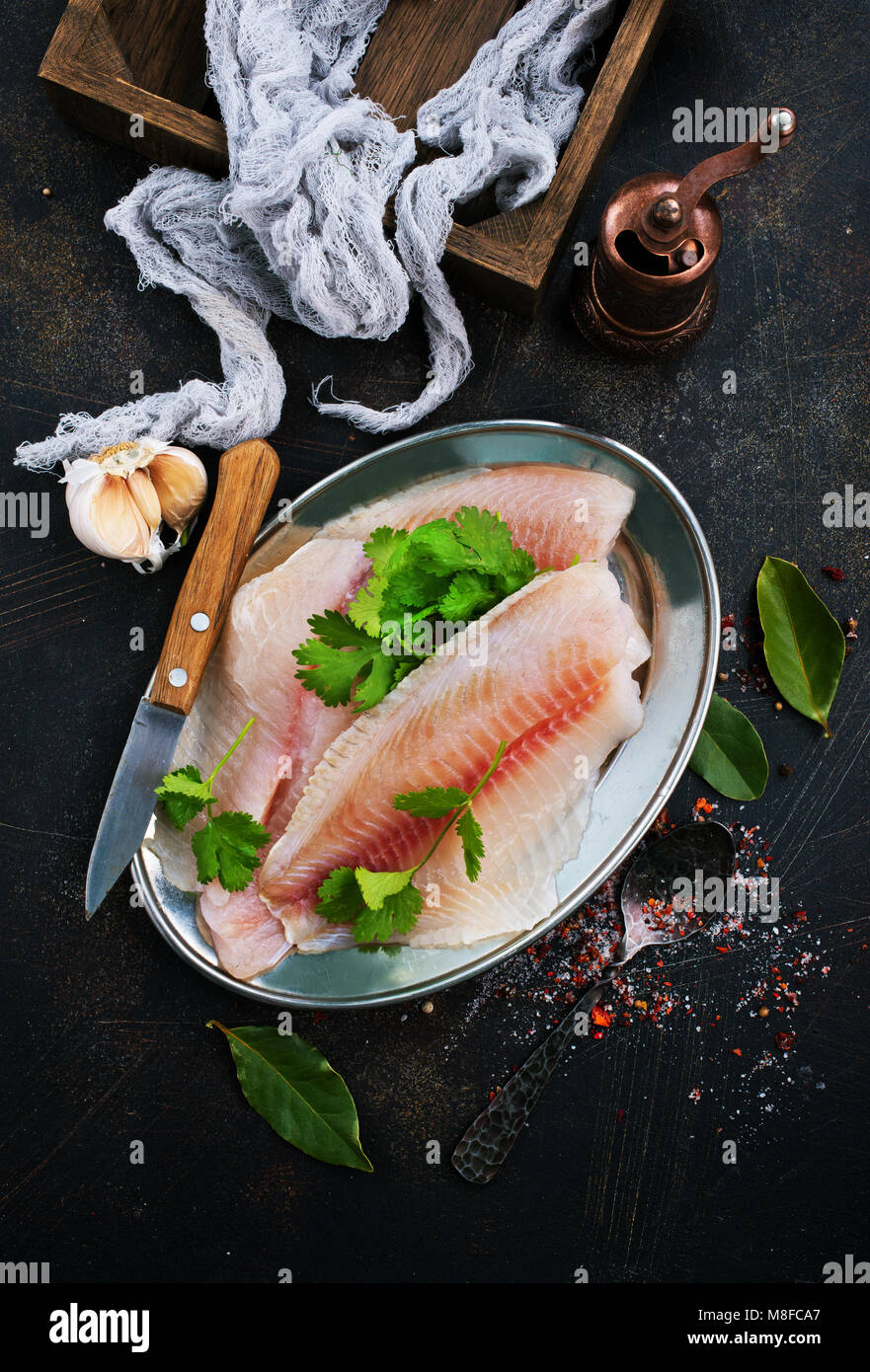 raw fish fillet with aroma spice on plate Stock Photo - Alamy