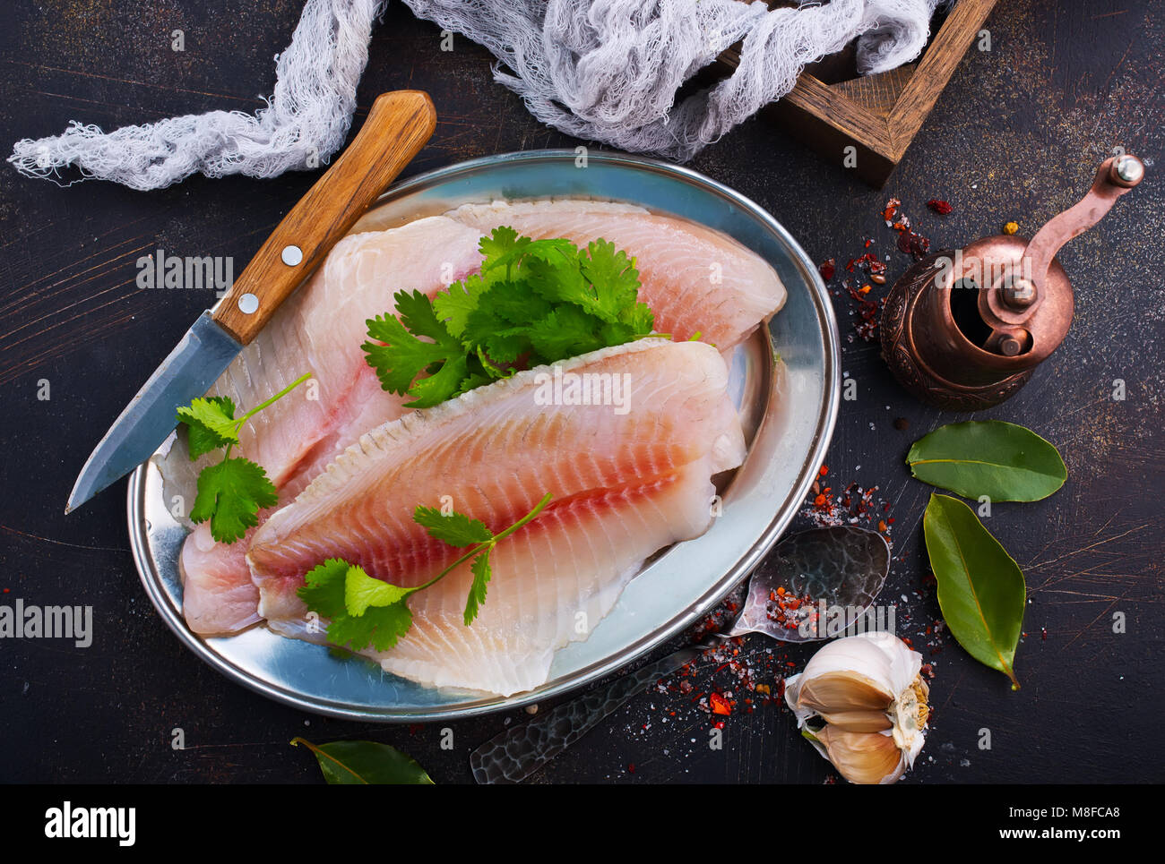 raw fish fillet with aroma spice on plate Stock Photo - Alamy
