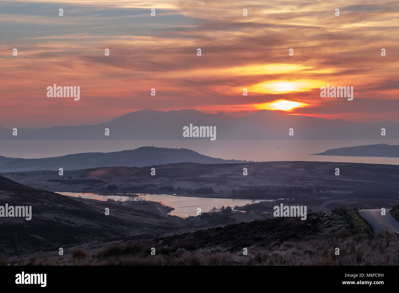 A firey sunset causing unusual reflections on the moorland as the sun ...