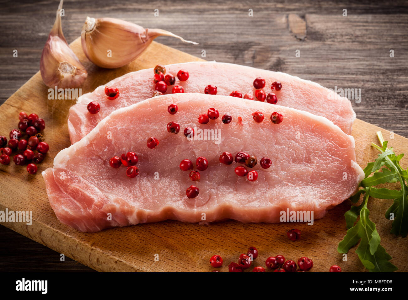 Raw pork chops on cutting board and vegetables Stock Photo - Alamy