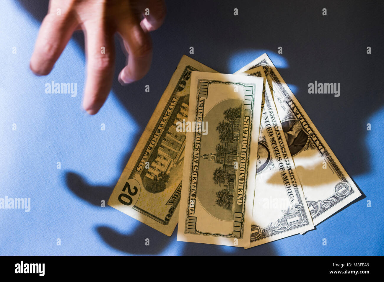 Shade From A Hand On Money Stock Photo - Alamy
