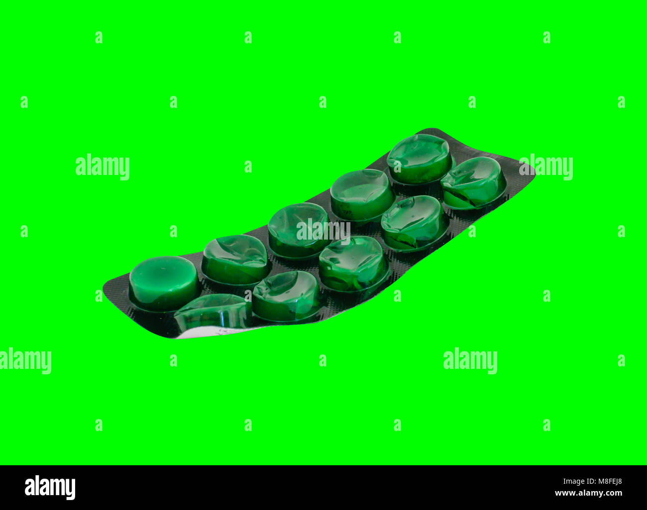 Used tablets in blister pack isolated on green background. Photo Stock ...