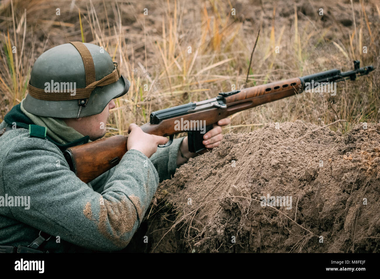 German soldier Wehrmacht in the trench with a Soviet automatic rifle ...