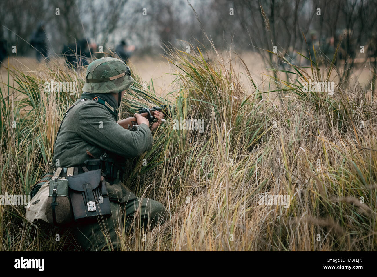 Soldier of the Wehrmacht of the Second World War sits in hiding with a ...