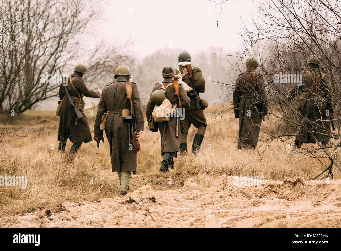 Soviet soldiers of the Red Army of the USSR are walking along the field ...