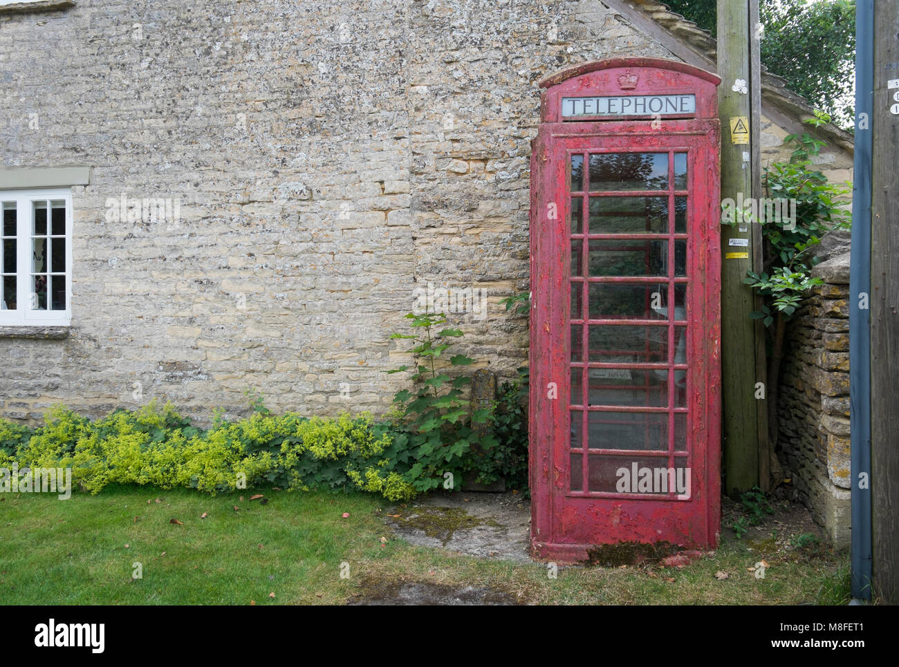 An old, neglected telephone box in Asthall, Oxfordshire, UK Stock Photo ...