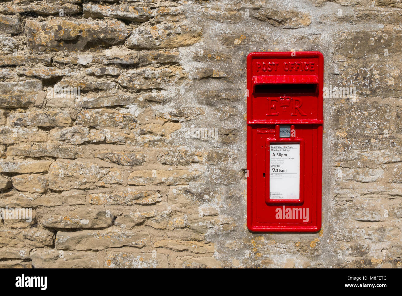 Red post box in the wall of a Cotswold house in Asthall, Oxfordshire ...