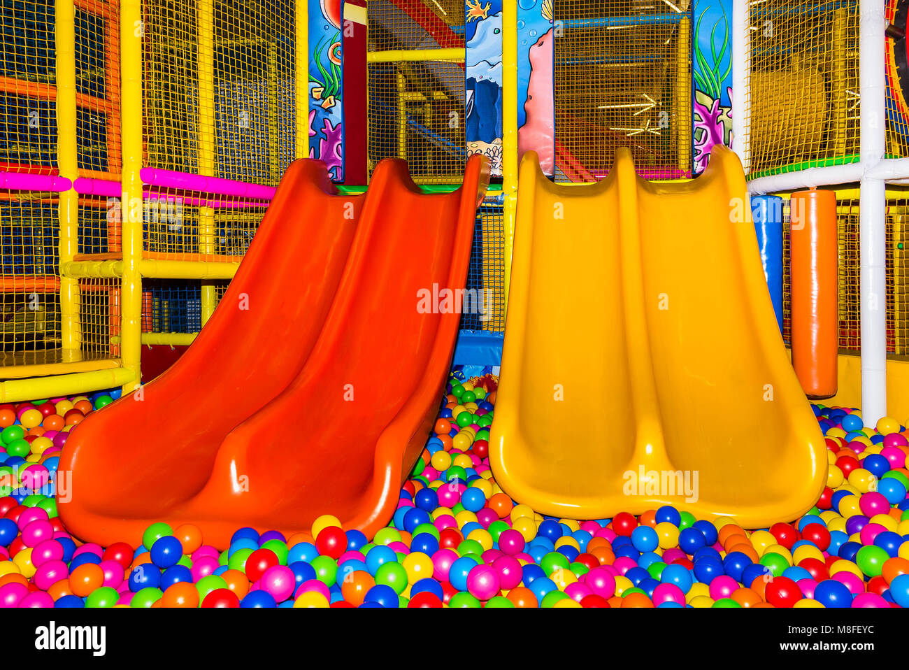 large children's playroom with a slide and colorful balls in ...