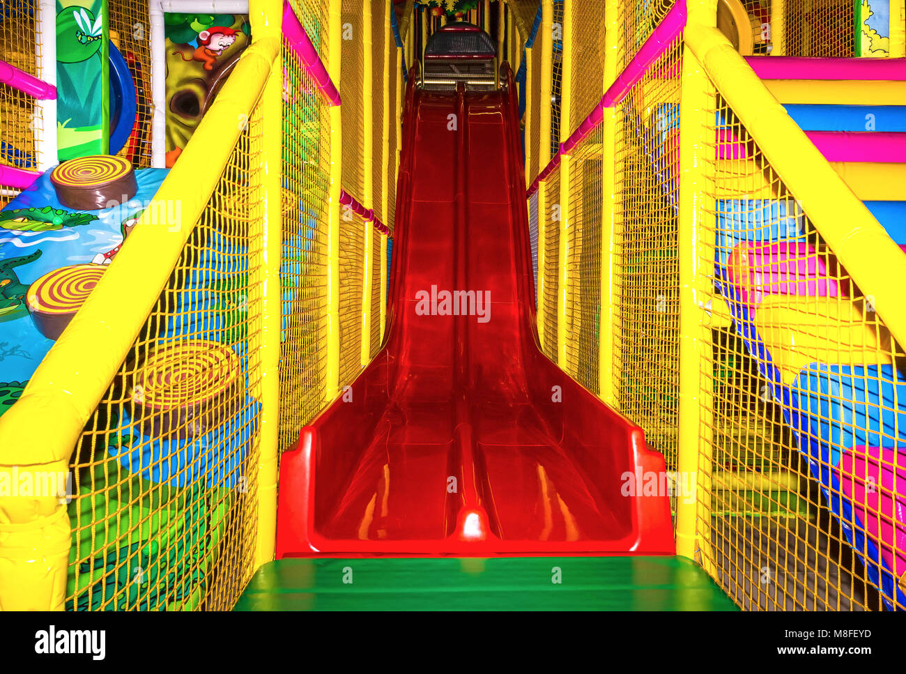 large children's playroom with a slide and colorful balls in ...