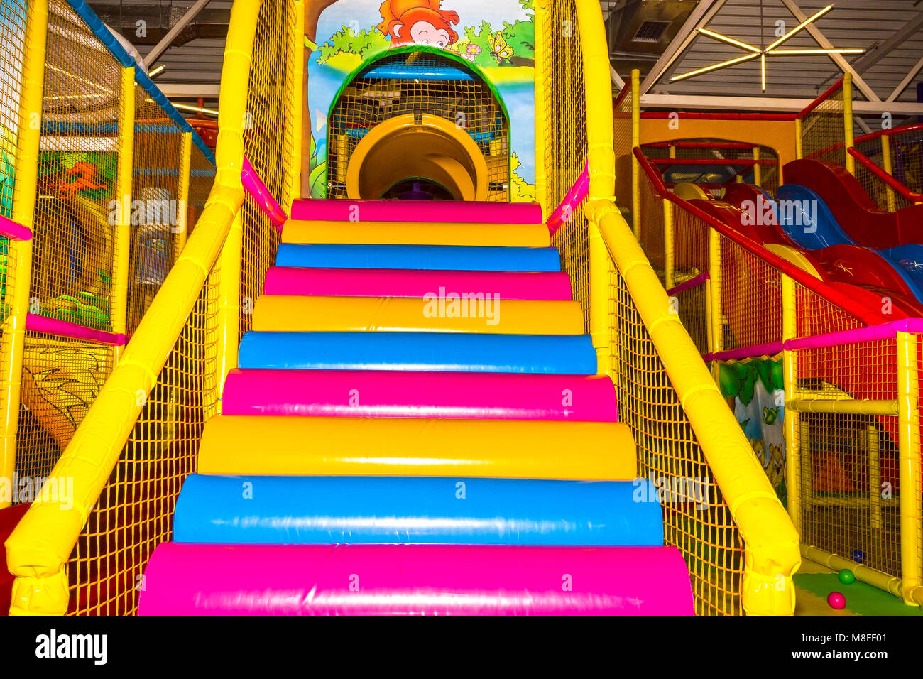 The abstract large children's playroom with a slide and colorful balls ...