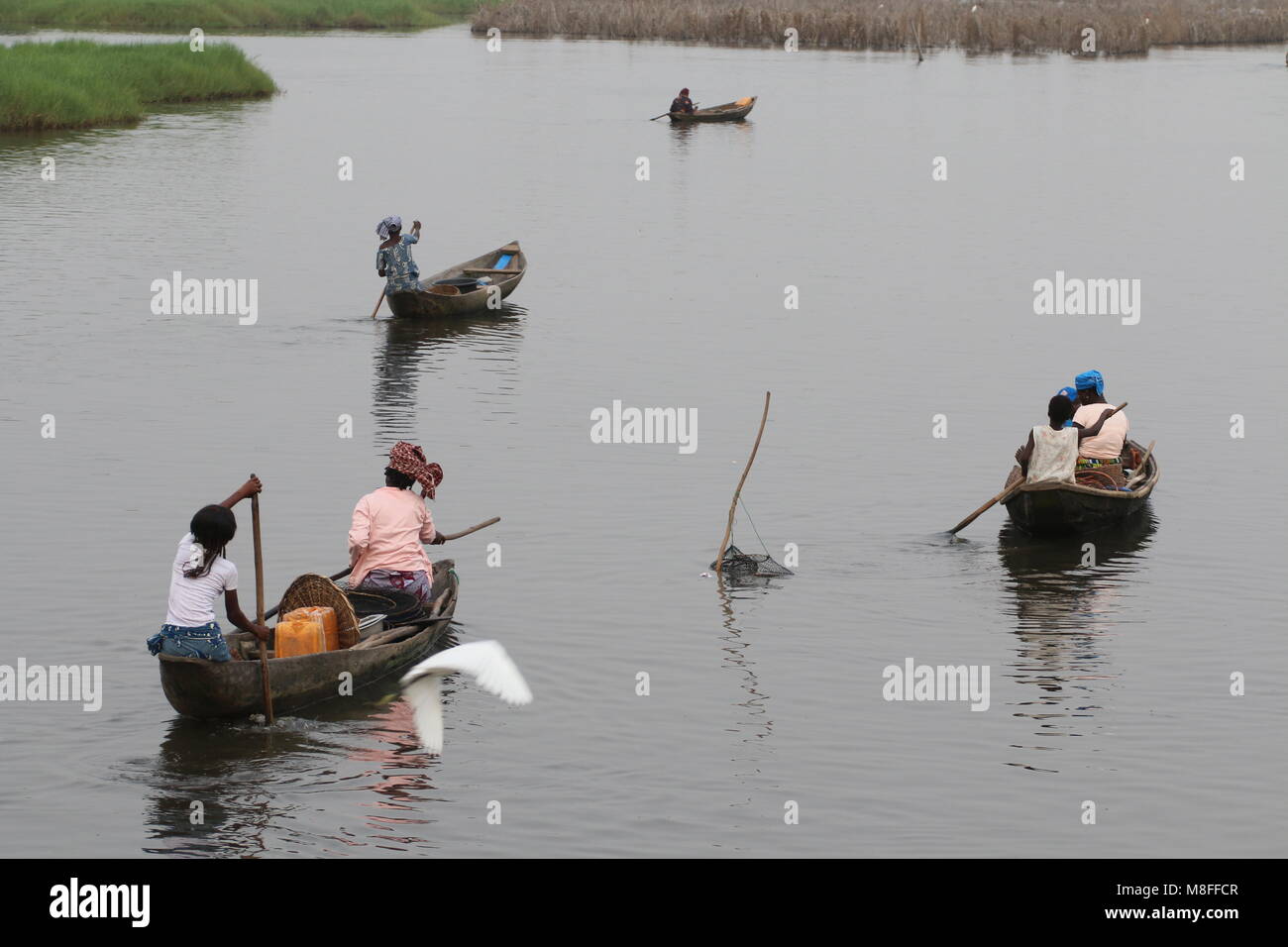 People in canoes paddling on the lake Stock Photo - Alamy