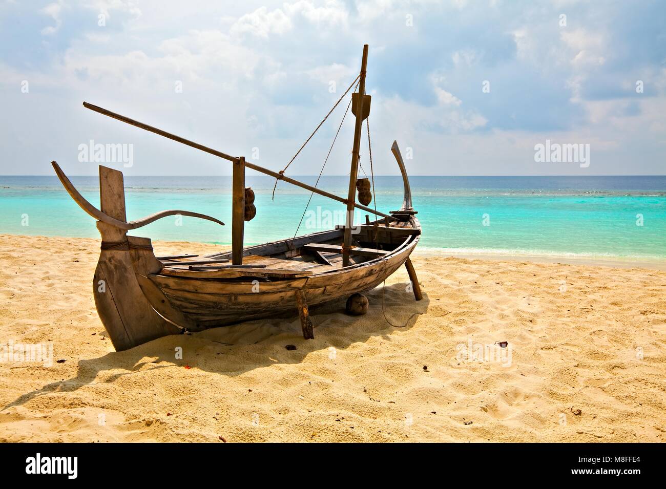 Old boat is on sandy beach, Maldives Stock Photo - Alamy