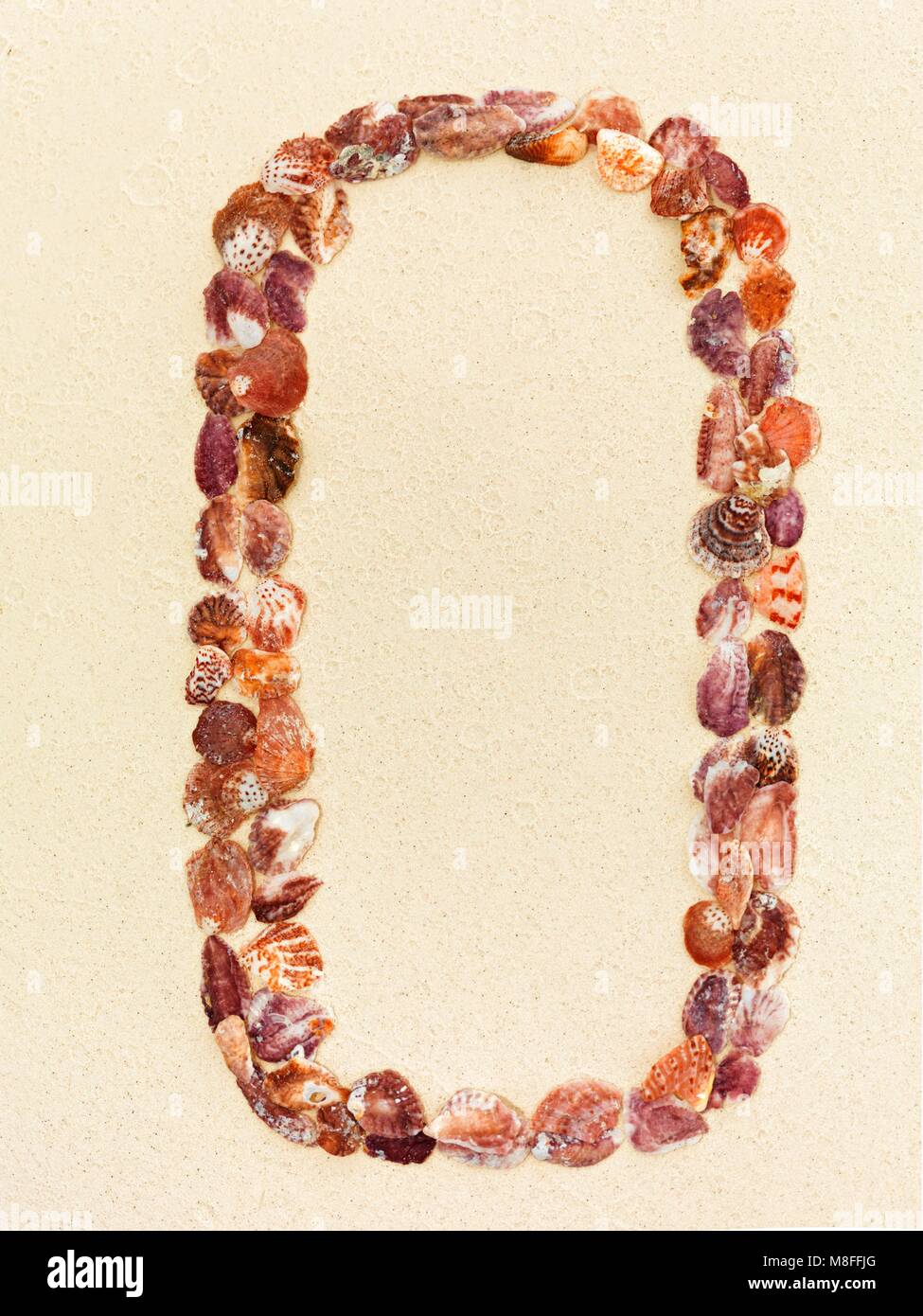 Digit zero made of seashells on a coral sandy beach Stock Photo - Alamy