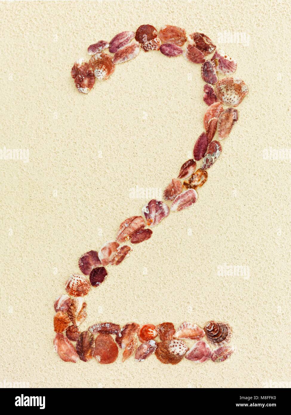 Digit two made of seashells on a coral sandy beach Stock Photo - Alamy